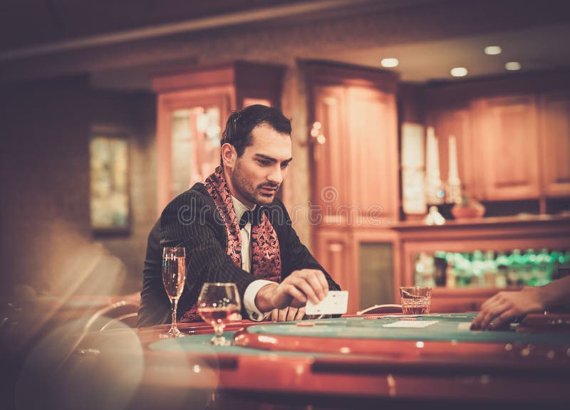 Man Sitting Behind Poker Table Stock Photo - Image of elegant, croup ...