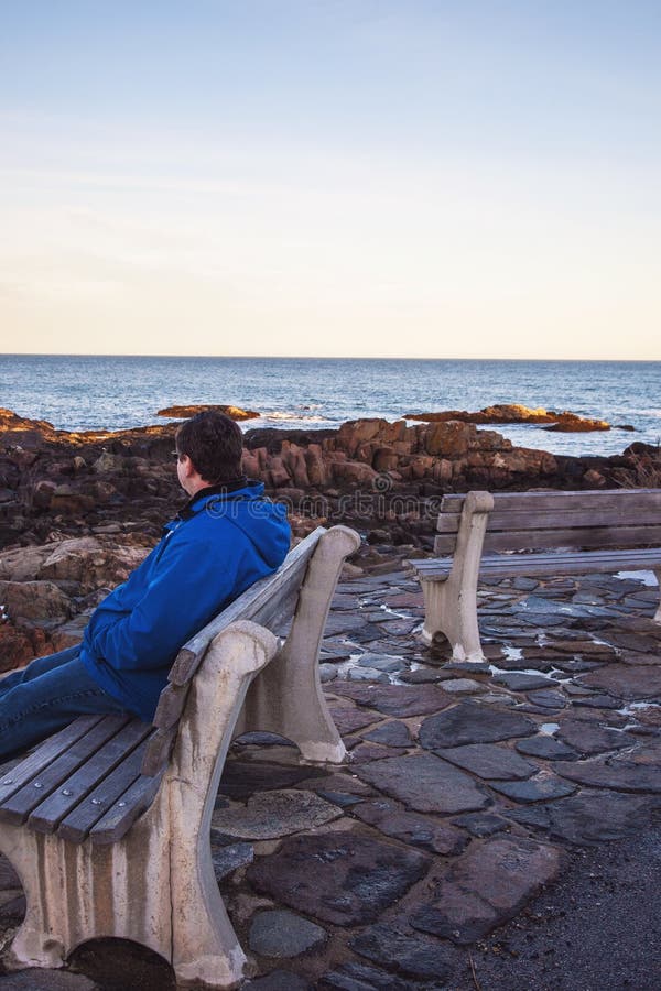 Man Sitting on a Bench on Marginal Way Path Along the Rocky Coast of ...
