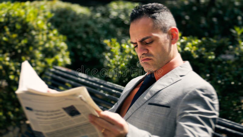 Man Sitting on the Bench Reads Newspaper Stock Photo - Image of ...