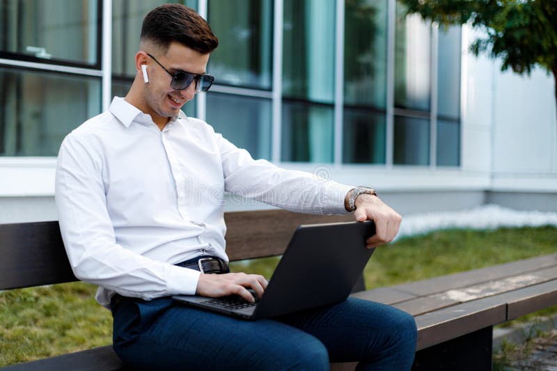 Man Sitting on Bench Using Laptop Computer Stock Image - Image of ...