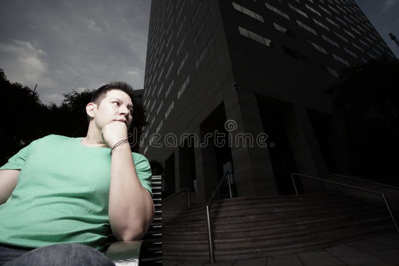 Man Sitting by a Building Under Construction Stock Photo - Image of ...