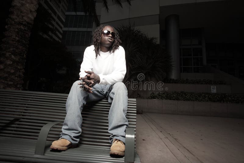 Man Sitting on a Bus Bench at Night Stock Photo - Image of tough, macho ...
