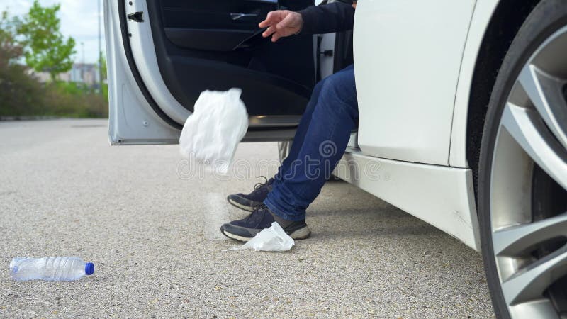 Man Sitting in a Car and Throwing Garbage on the Road, Dirtying the ...