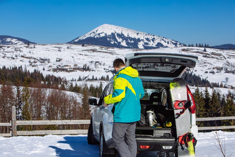 Man Sitting in Car Trunk Changing for Snowboard Stock Image - Image of stuff, snowboard: 228334539
