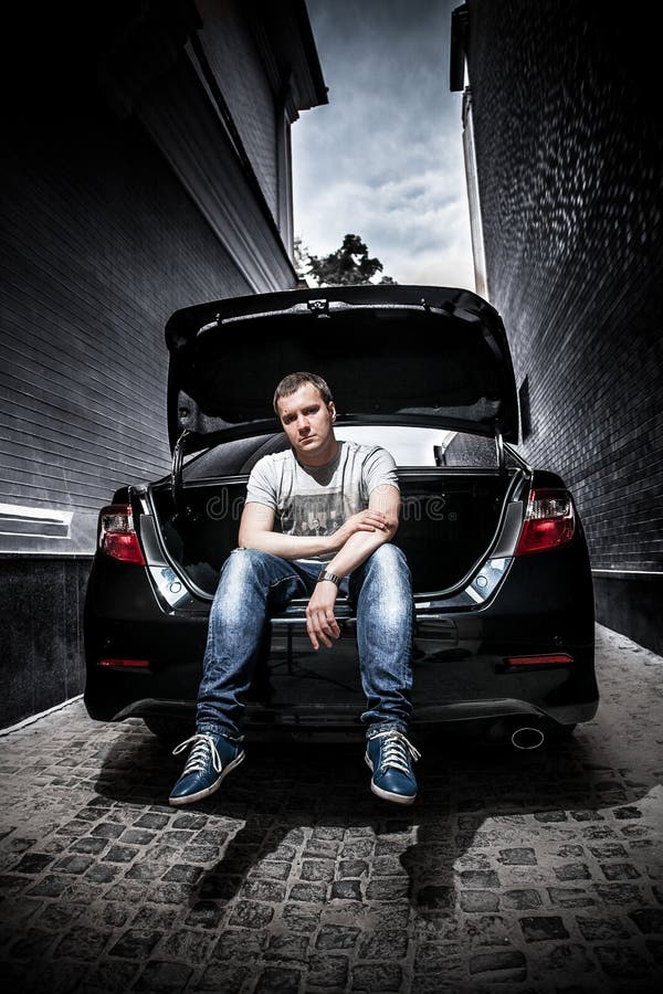 Man sitting in car trunk stock photo. Image of rear, boot - 34133472