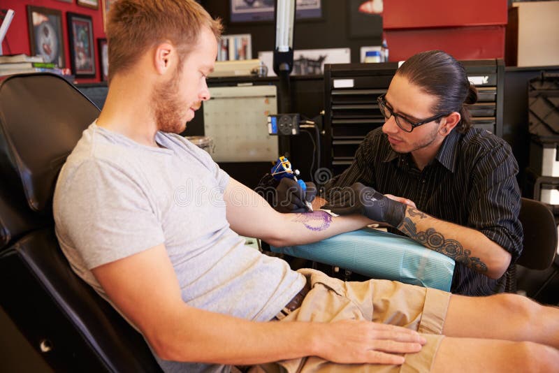 Man Sitting in Chair Having Tattoo on Arm in Parlor Stock Image - Image ...