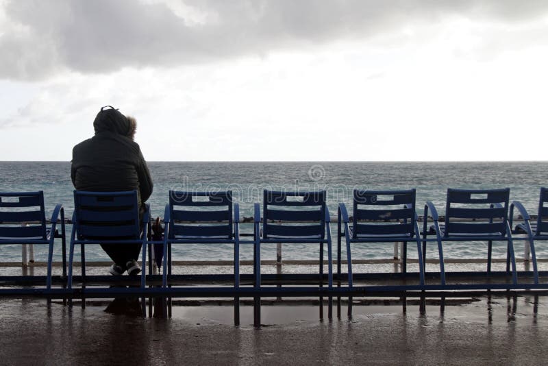 Man Sitting on a Chair Looking at the Ocean Under a Cloudy Sky Stock ...