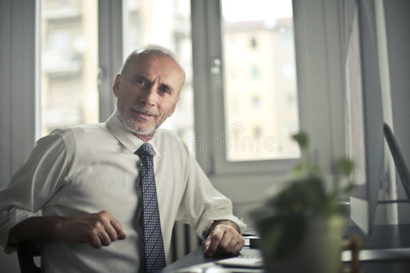 Man Sitting On Chair Beside Table Picture. Image: 109926480