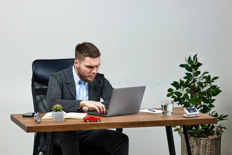 Man Sitting on Chair at Table and Resting, Using Laptop Stock Photo ...