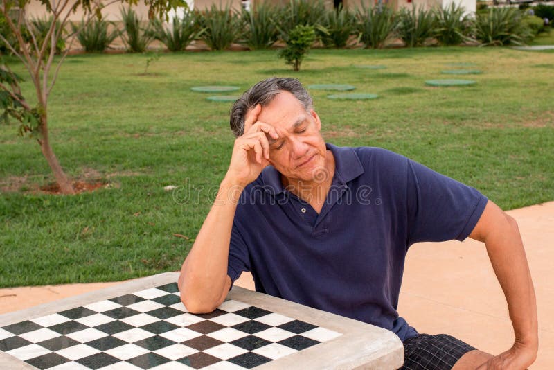 Man Sitting at a Checkerboard Table Stock Photo - Image of leisure ...