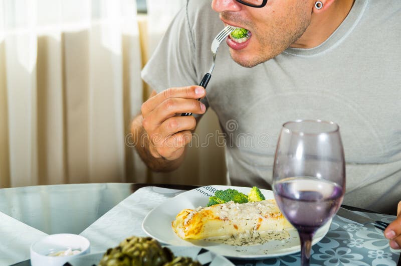 Man Sitting by Classy Dinner Setting Eating Fork with Broccoli, Crepe ...