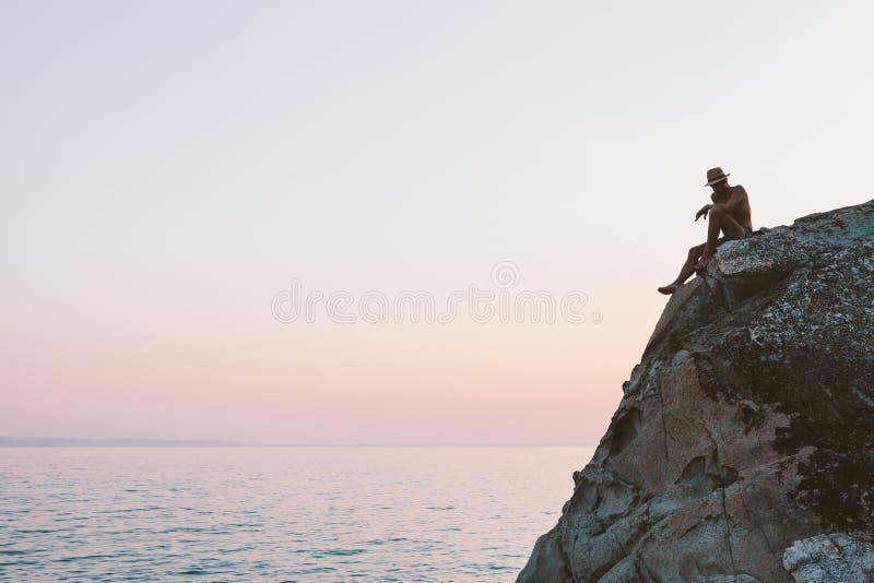 Man sitting on cliff top stock image. Image of outdoor - 77034159