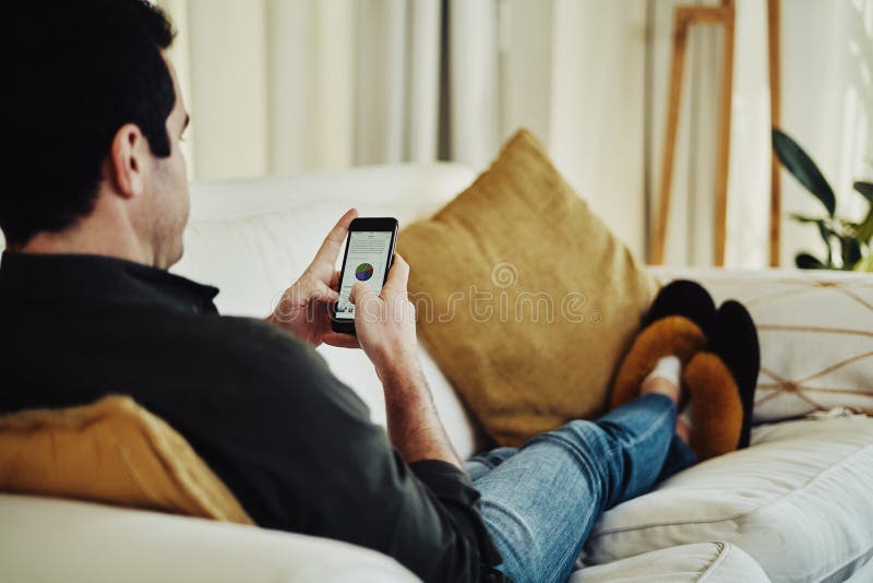 Man Sitting Comfortable on Sofa Using Mobile Phone Stock Photo - Image ...