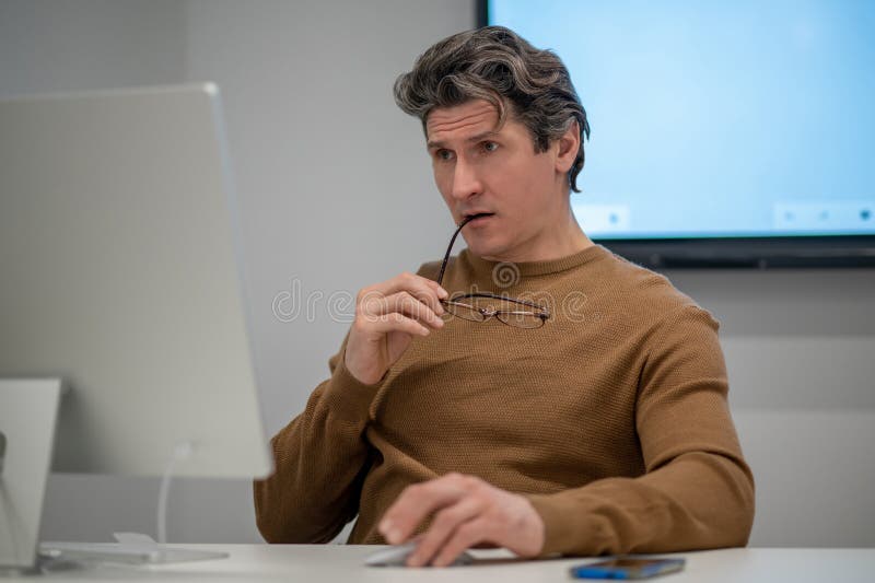 A Man Sitting at the Computer and Looking Concentrated Stock Photo ...
