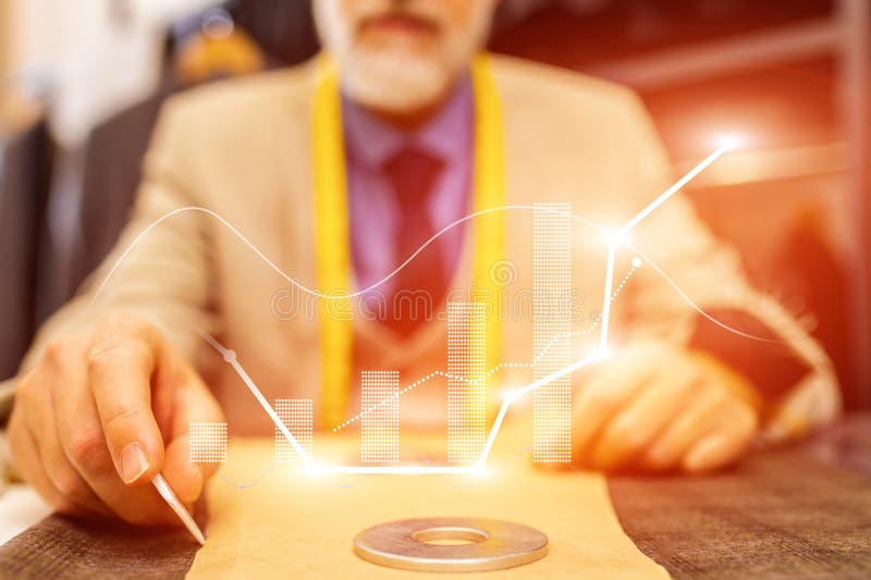 A Man is Sitting at a Desk with a Graph on a Piece of Paper Stock Photo ...
