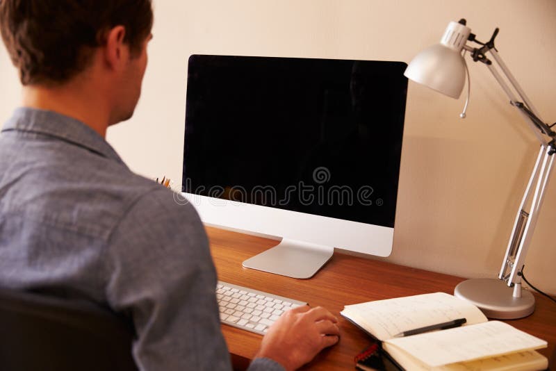 Man Sitting at Desk Working at Computer in Home Office Stock Image ...