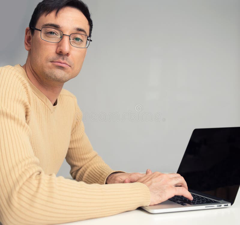 Man Sitting at Desk, Working on Laptop Computer Stock Photo - Image of ...