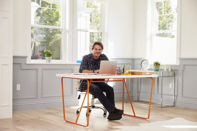 Man Sitting at Desk Working at Laptop in Home Office Stock Image ...