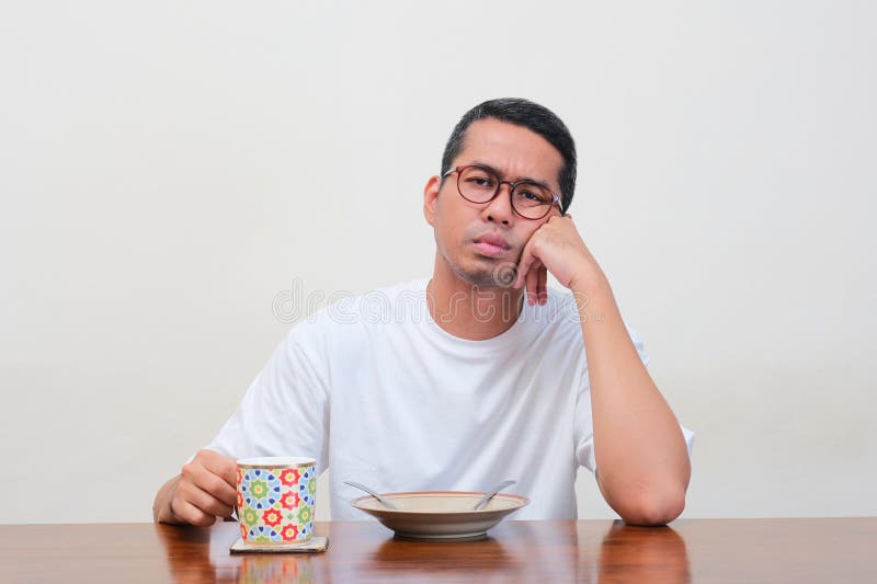 A Man Sitting on Dinning Table with Sad Expression Stock Image - Image ...