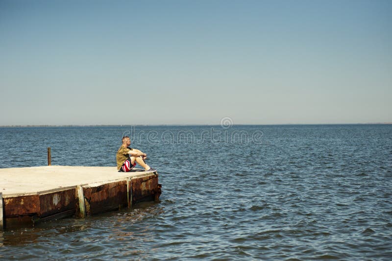 Man Sitting On Dock Picture. Image: 116504775