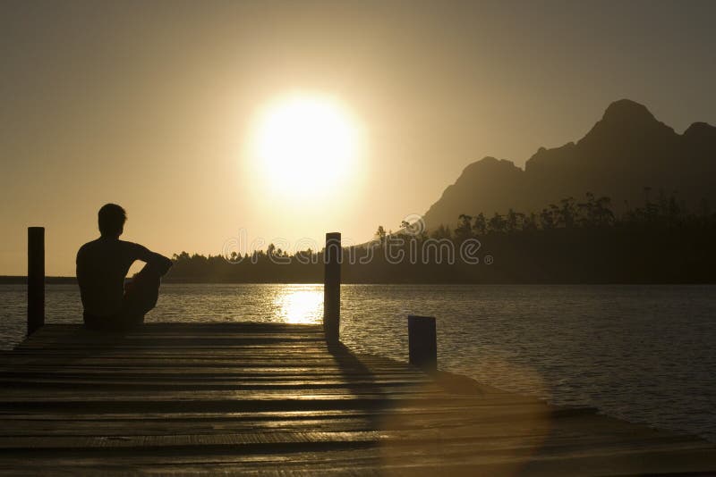 Man Sitting on Dock by Lake Stock Photo - Image of leisure, caucasian ...