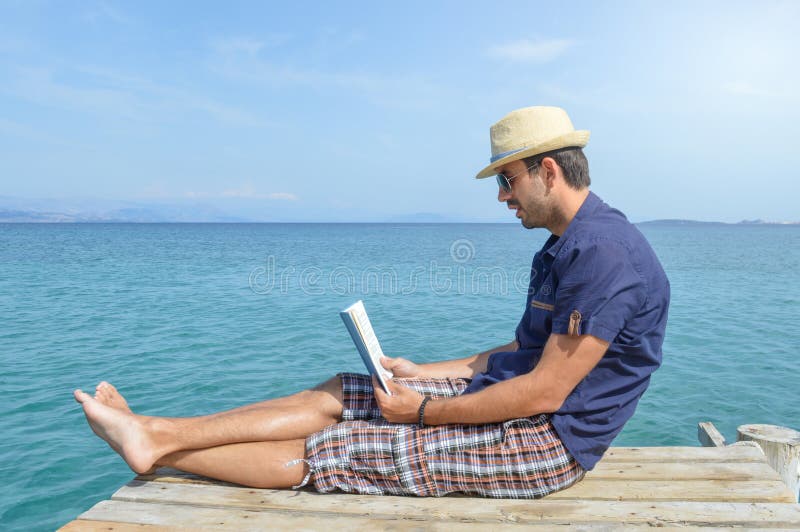 Man Sitting on the Dock Reading a Book Stock Photo - Image of ...