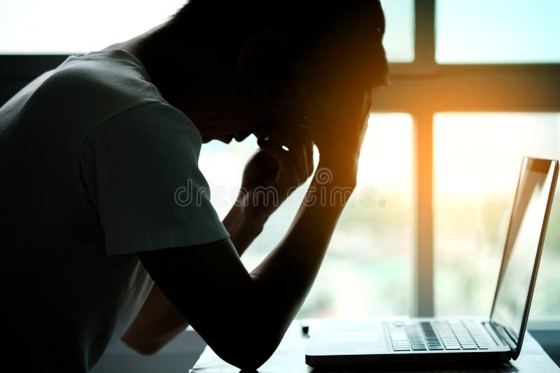A Man Sitting Down, His Face Unsettled. at the Computer Desk he Has ...