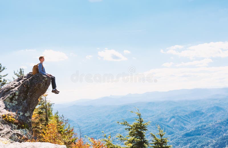 Man Sitting on the Edge of a Cliff Overlooking Stock Image - Image of ...