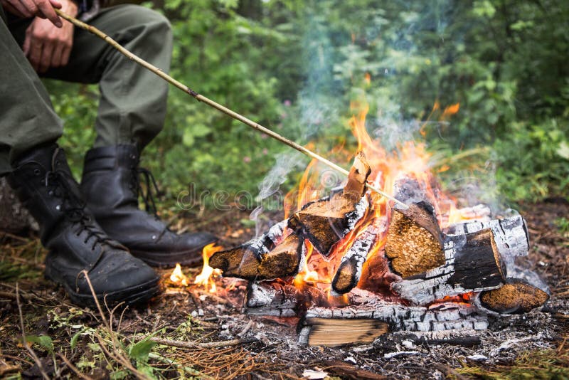 The Man Sitting by the Fire in the Forest. Stock Image - Image of ...
