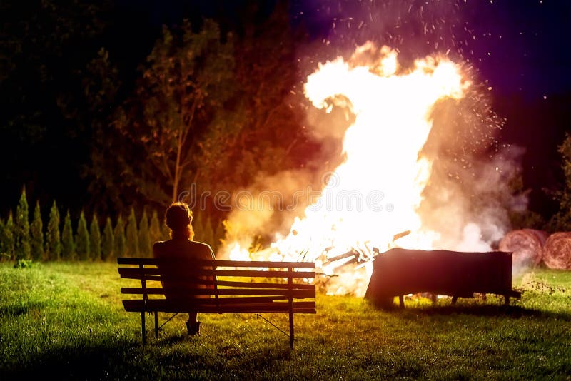 Man Sitting by the Fire and Looking To the Flame. Stock Photo - Image ...