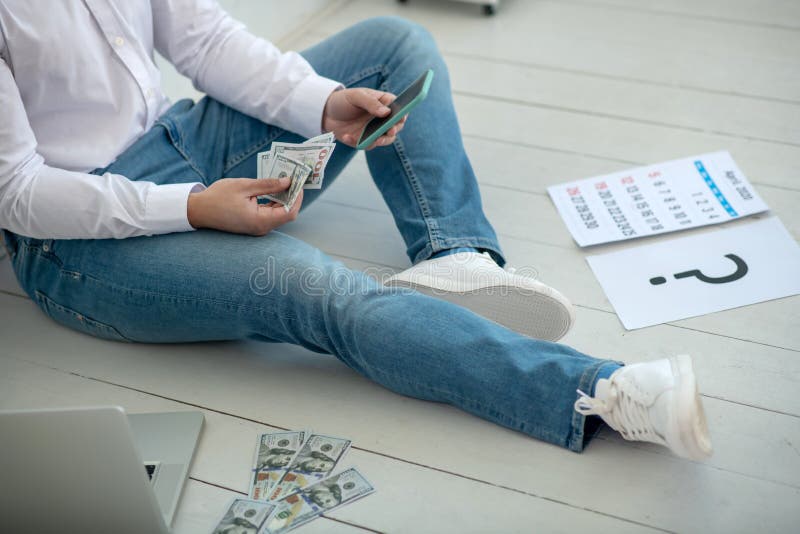 Man Sitting on the Floor and Counting the Rest of Money Stock Photo ...