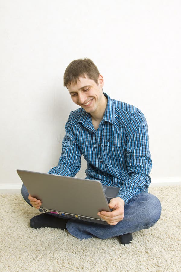 Man Sitting on the Floor Using a Laptop Stock Image - Image of sitting ...
