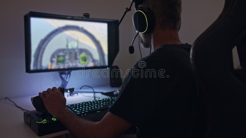 Man Playing a Flight Simulator on the Computer, Wearing a Headset Stock ...