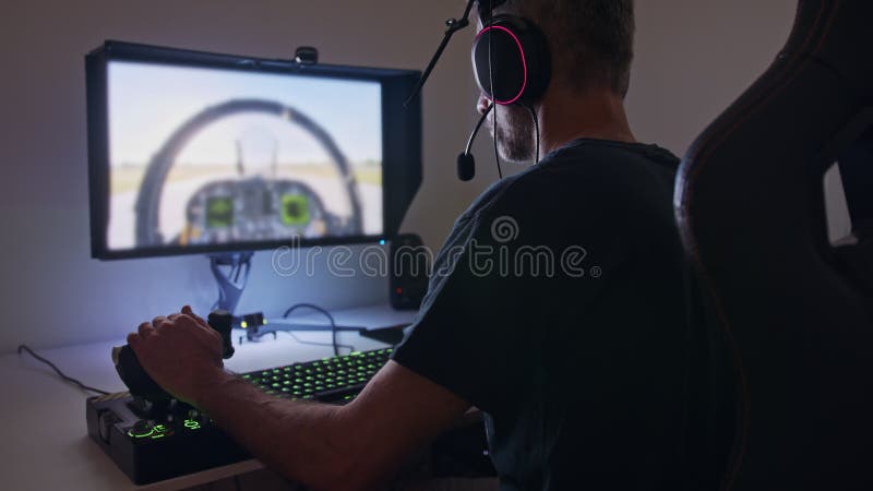 Man Playing a Flight Simulator on the Computer, Wearing a Headset Stock ...
