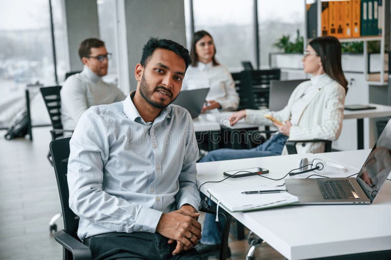 Man is Sitting in Front of His Colleagues. Four People are Working in ...