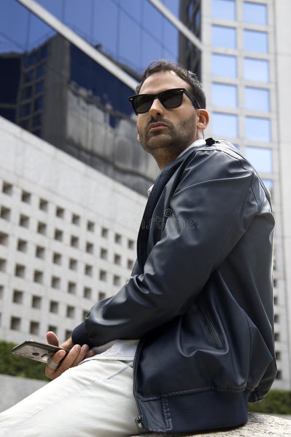 Man Sitting in Front of an Office with Sunglasses Stock Image - Image ...