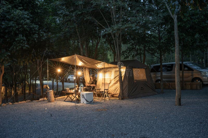 Man Sitting in Front of Tent at Night Time and Romantic Lighting ...