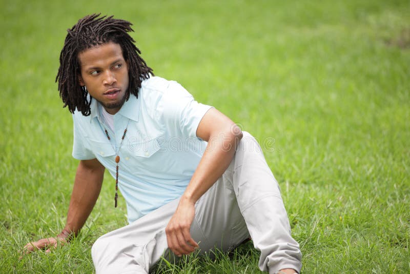 Man Sitting On The Grass Stock Image Image Of American 24987505