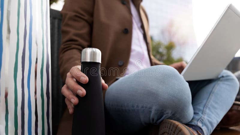 Man Sitting with His Computer Holding His Bottle with His Hand Stock ...