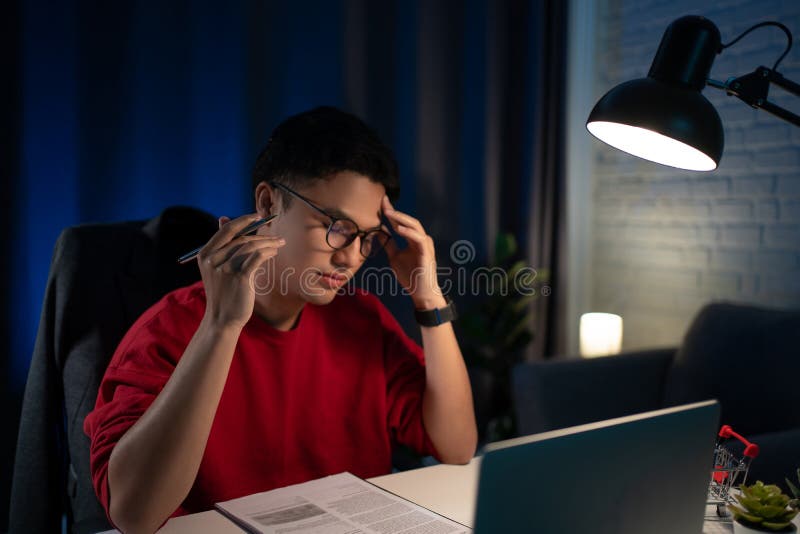 Man Sitting in His Room Working Late at Night Feeling Very Tired Stock ...
