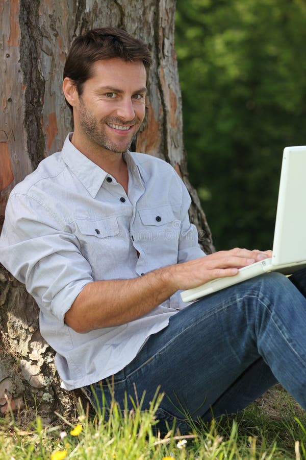 Man sitting with laptop stock photo. Image of portrait - 27910594