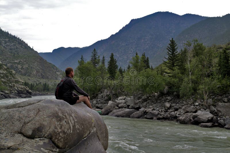 Man Sitting on a Large Rock Over Mountain River Stock Image - Image of ...