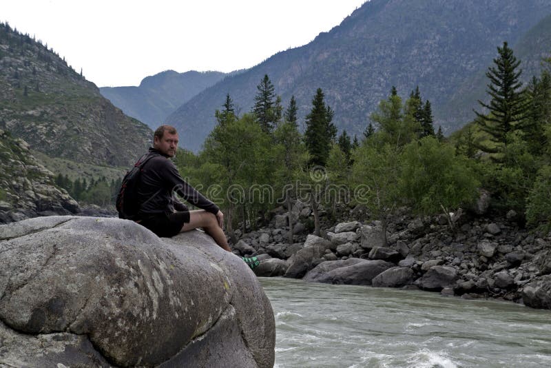Man Sitting on a Large Rock Over Mountain River Stock Photo - Image of ...
