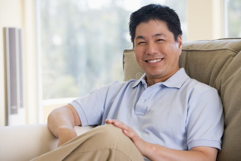 Man Sitting in Living Room Smiling Stock Photo - Image of person ...