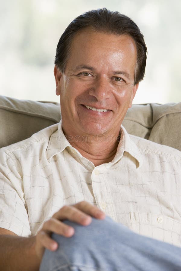 Man Sitting in Living Room Smiling Stock Photo - Image of lifestyle ...