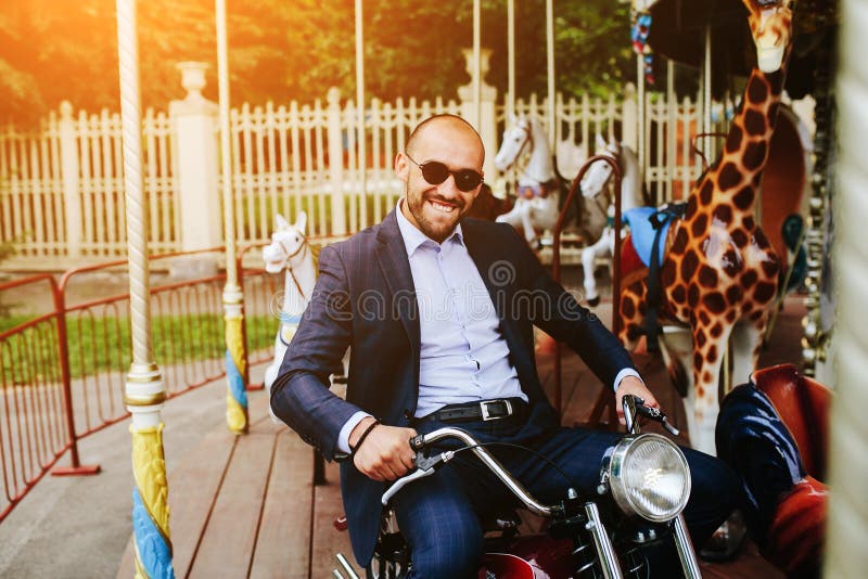 Man Sitting at Motorcycle on the Carousel Stock Photo - Image of ride ...