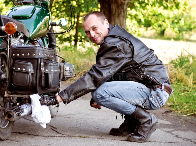 Man sitting by motorcycle stock photo. Image of lifestyle - 33613546