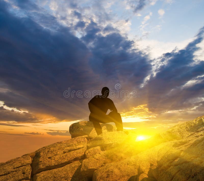 Man Sitting on a Mountain Top Stock Image - Image of blue, sport: 20587169