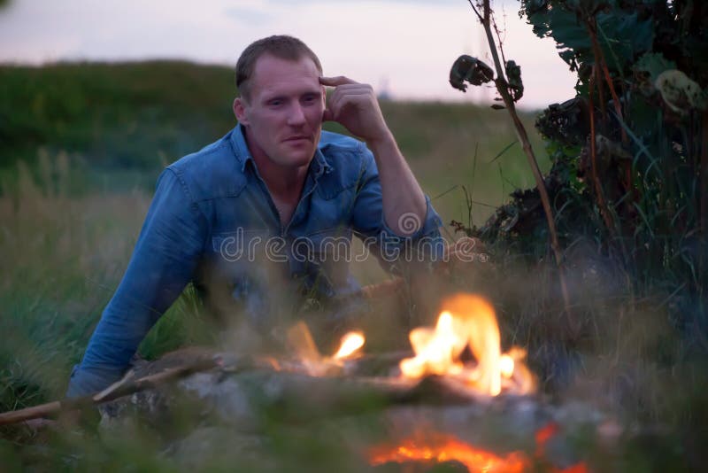 Man sitting near bonfire stock image. Image of outdoor - 59581925
