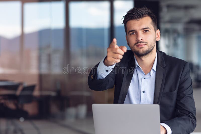 Man Sitting at Office Desk with Laptop Pointing Stock Image - Image of ...